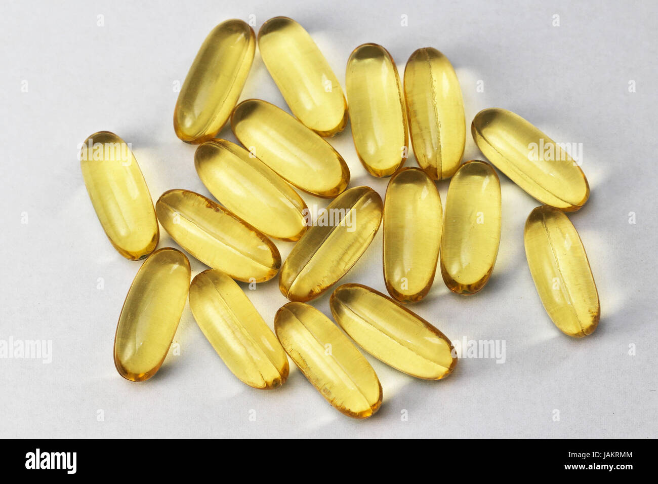 Very big size yellow omega oil pill supplements Stock Photo - Alamy