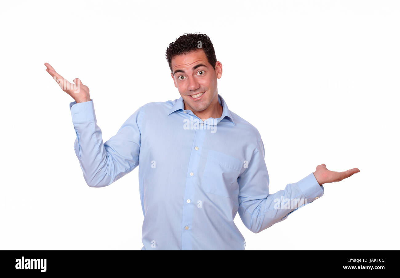 Portrait of a surprised handsome man holding out his hands and looking ...