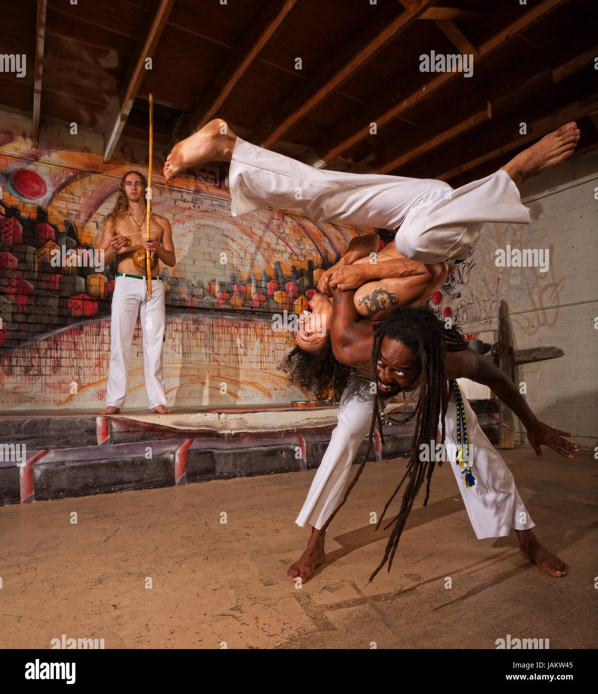Capoeira man throwing partner over his shoulders Stock Photo - Alamy