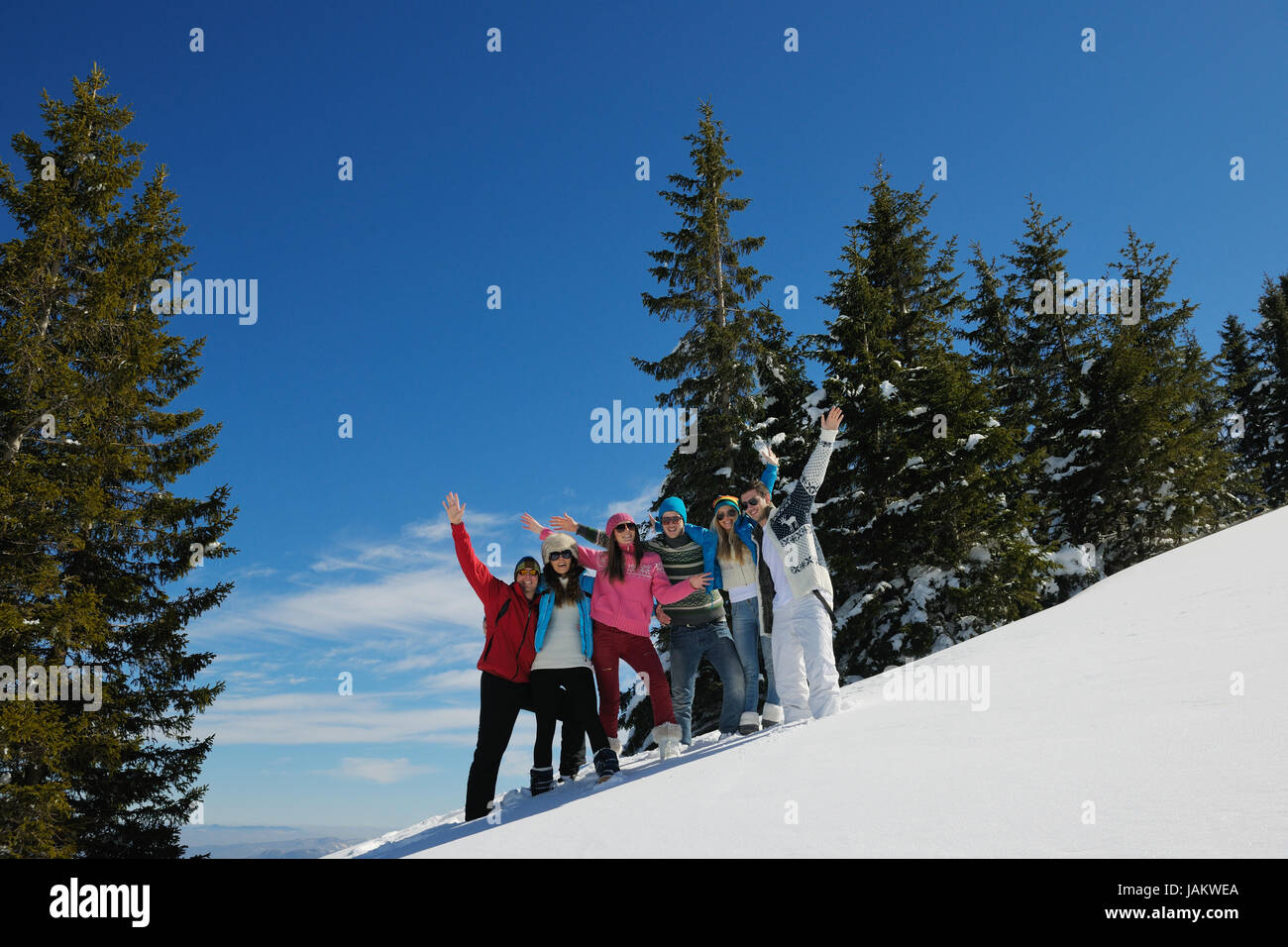 happy friends have fun at winter on fresh snow, healthy young people ...