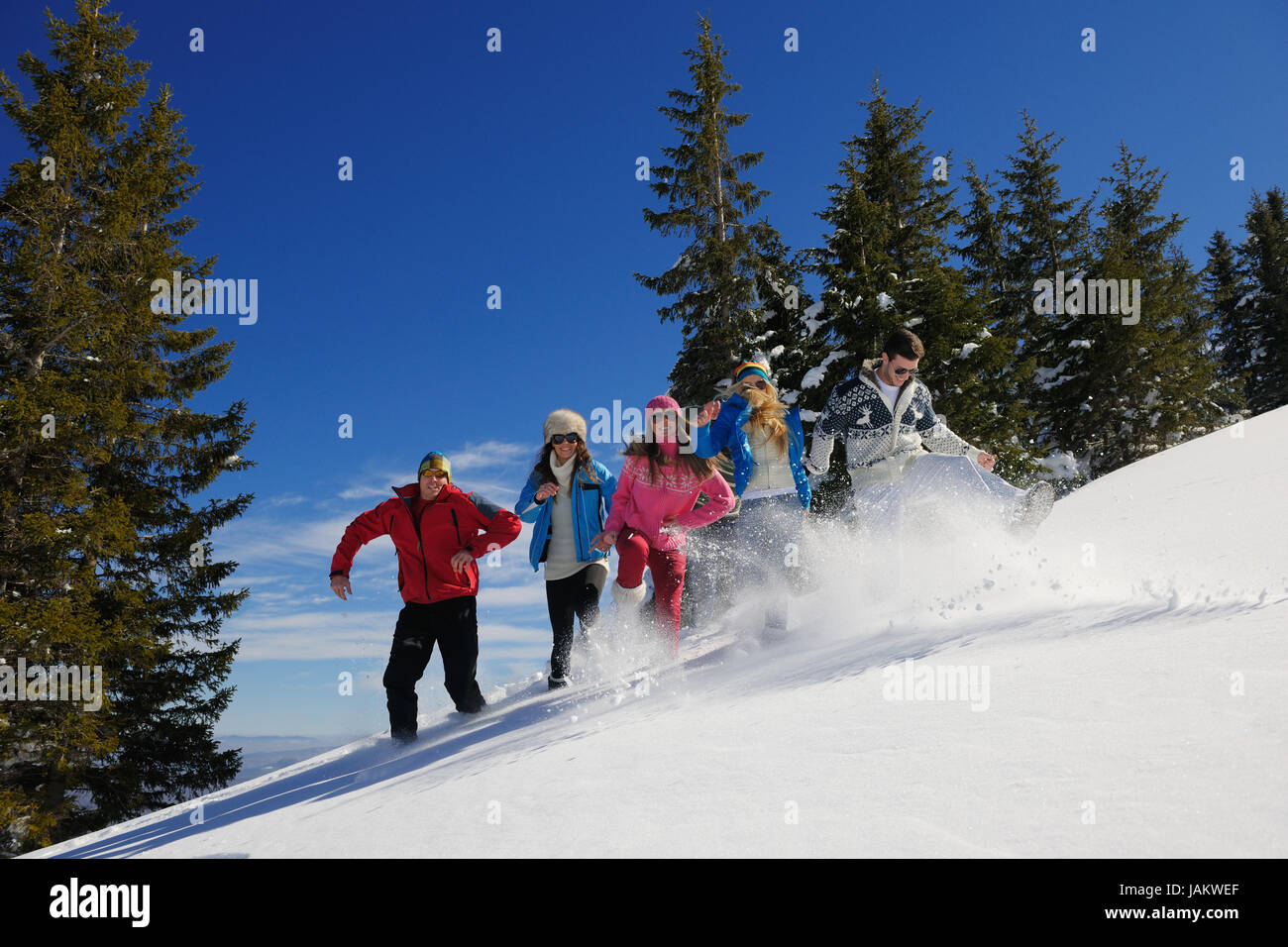 happy friends have fun at winter on fresh snow, healthy young people ...