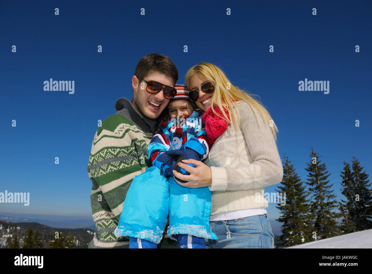 Winter season. Happy family having fun on fresh snow on vacation Stock ...