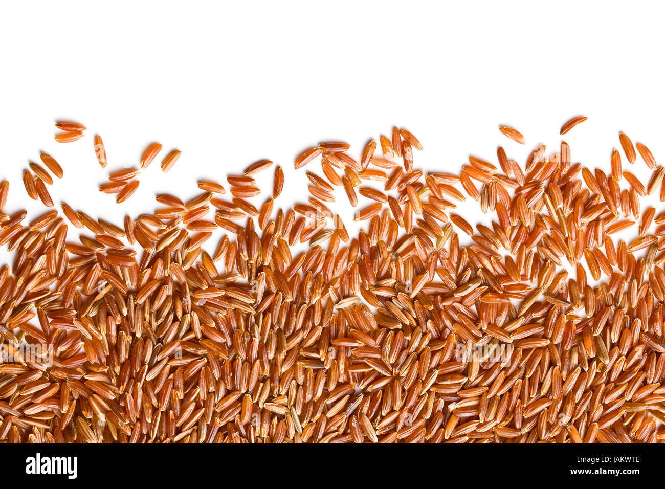 red raw rice on white background Stock Photo - Alamy