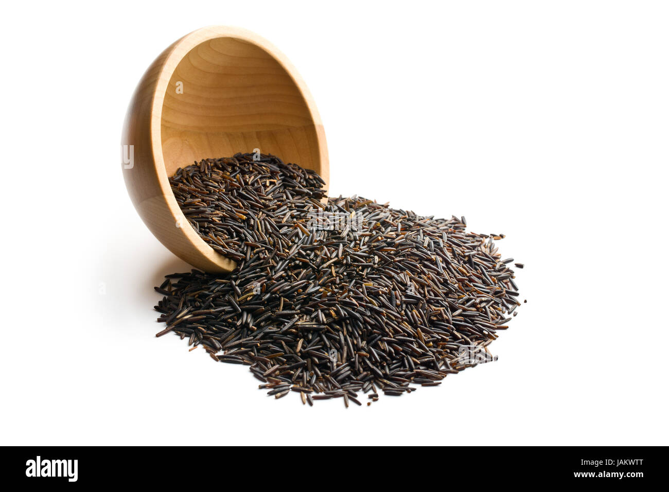 wild rice poured out from the wooden bowl Stock Photo - Alamy