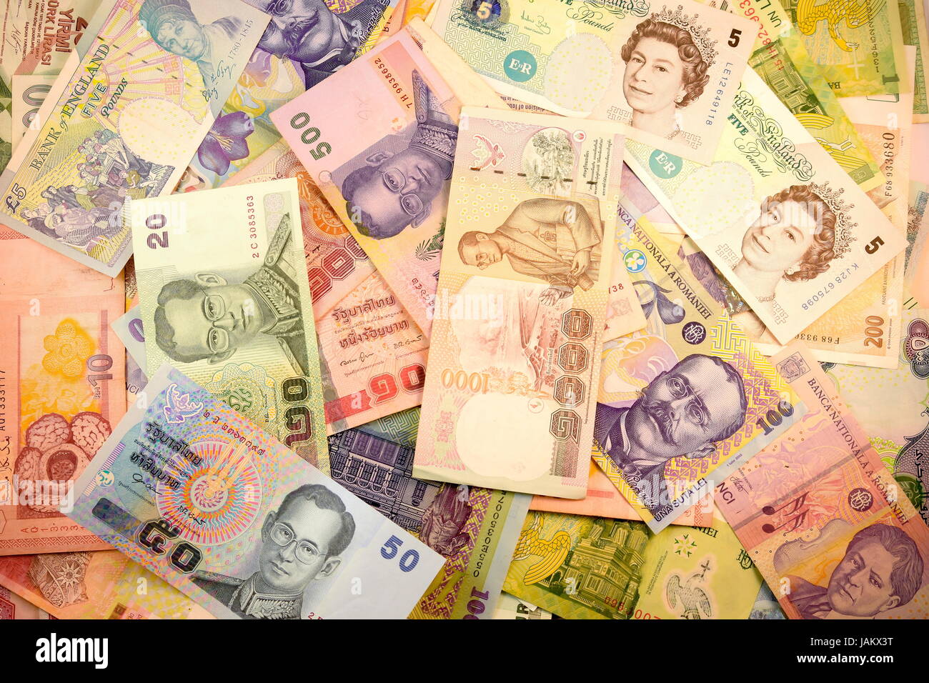 Different currency note and coins from different countries background ...