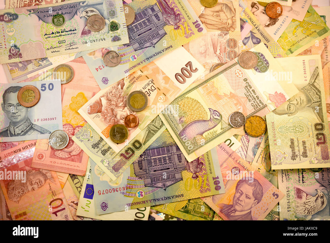 Different currency note and coins from different countries background ...