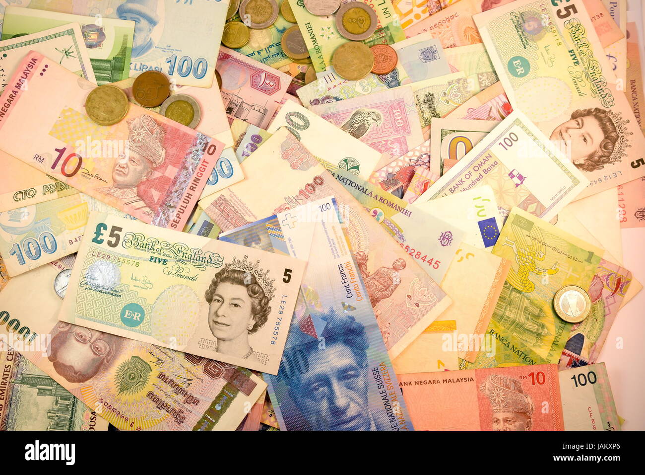 Different currency note and coins from different countries background ...