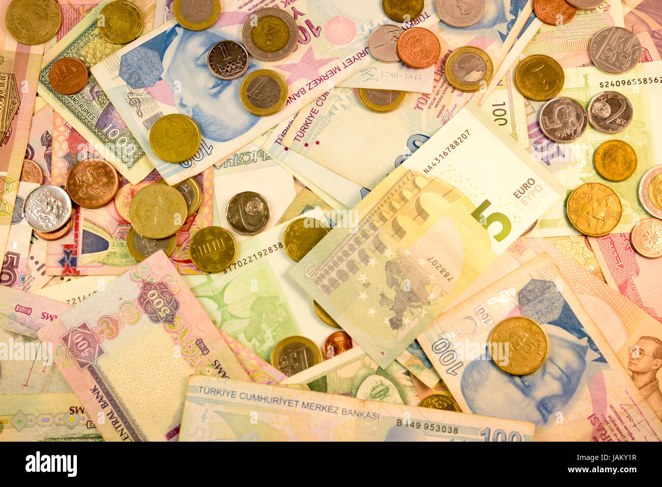 Different currency note and coins from different countries background ...