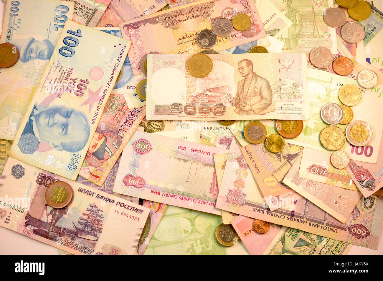 Different currency note and coins from different countries background ...