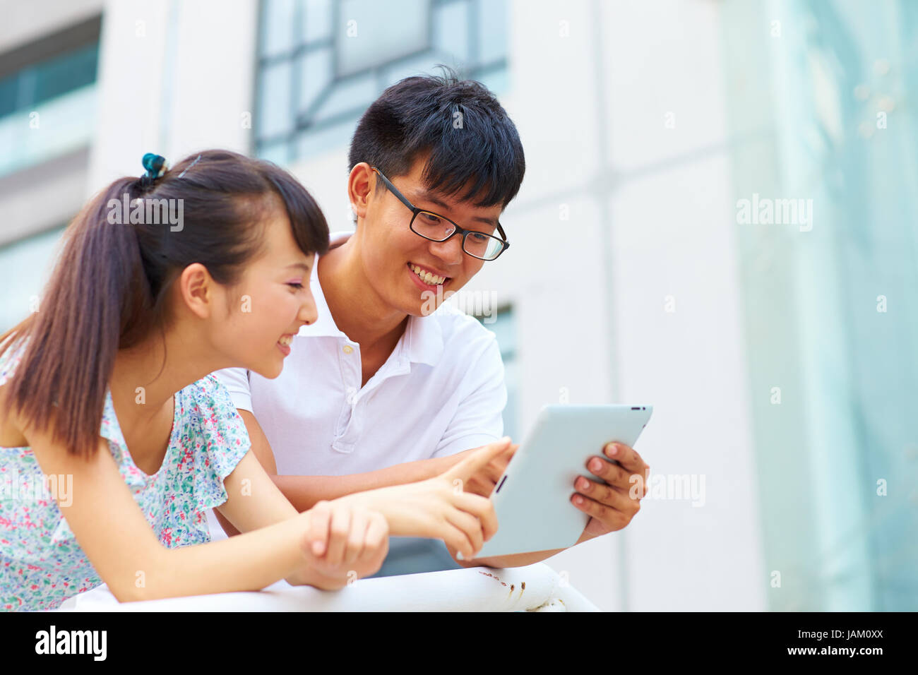 happy young asian or Chinese people using tablet outdoor Stock Photo ...