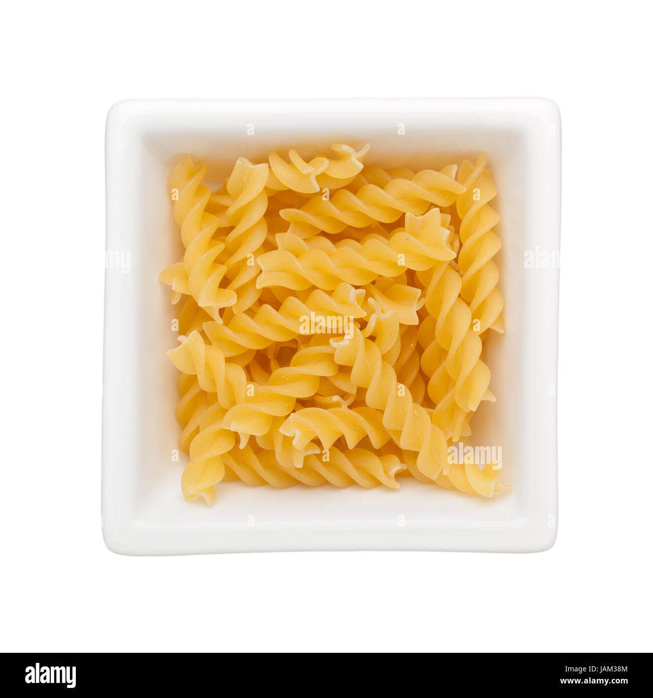 Uncooked fusilli in a square bowl isolated on white background Stock ...