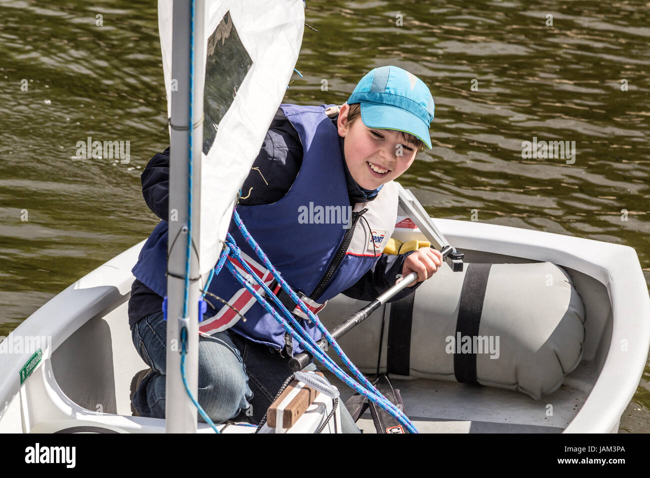 Young boy - sailor on Optimist class sailboat, after regatta race Stock ...