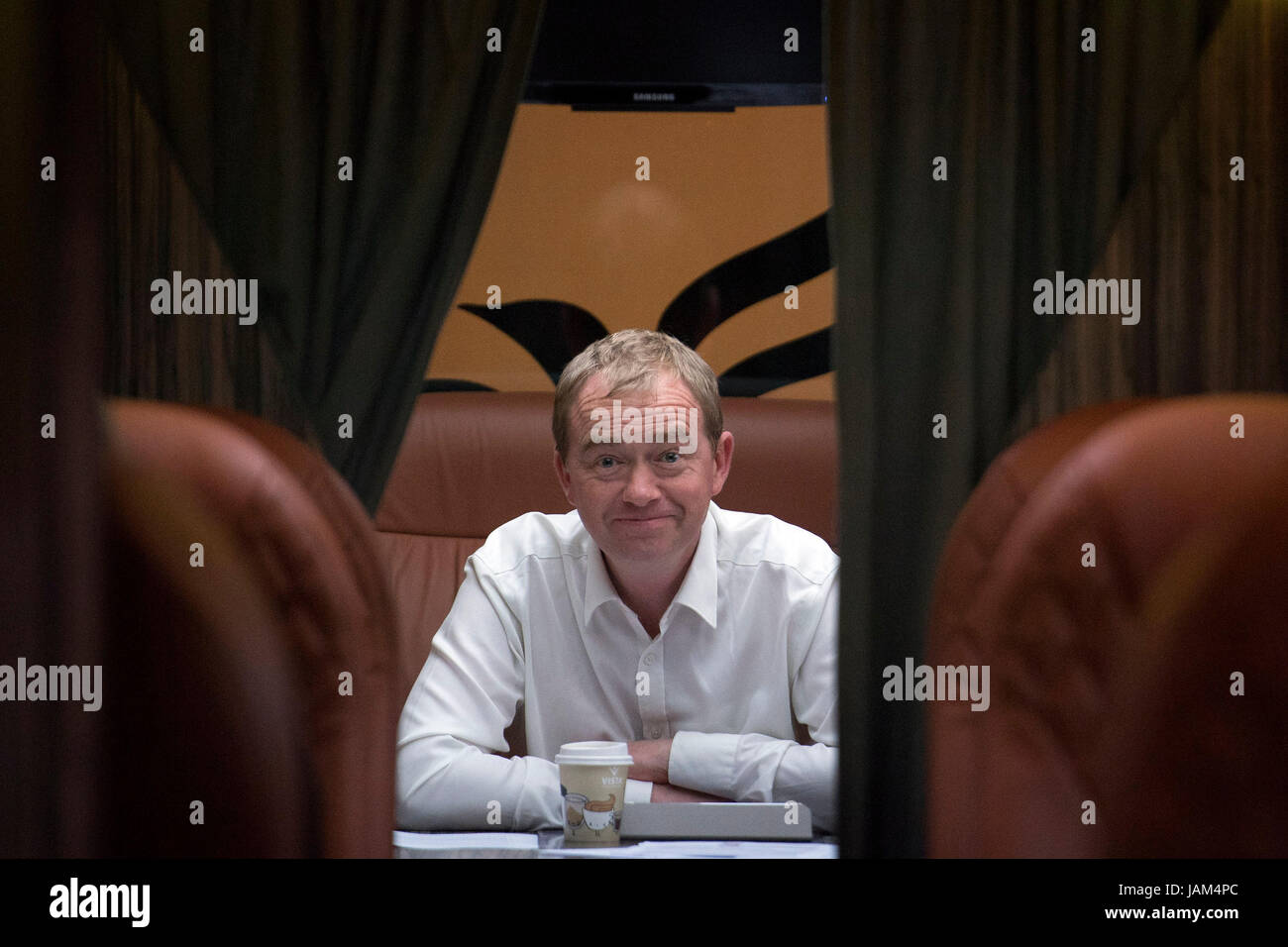 Liberal Democrats leader Tim Farron works on the battle bus during the ...