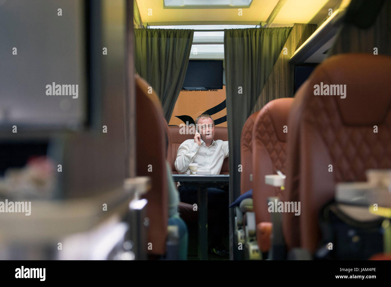 Liberal Democrats leader Tim Farron works on the battle bus during the ...