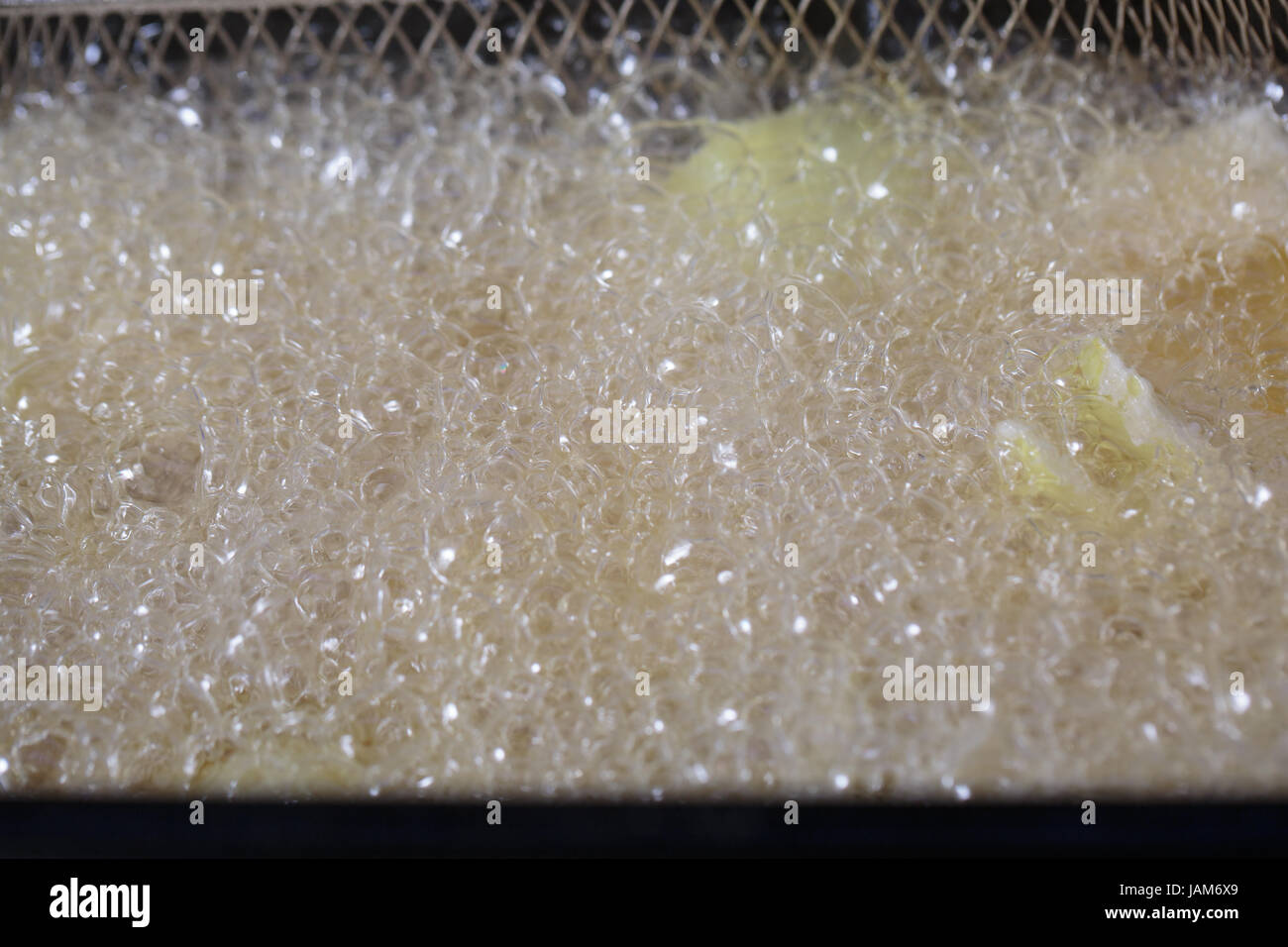 Foam from oil whan Onion being cooked in electric fryer Stock Photo - Alamy