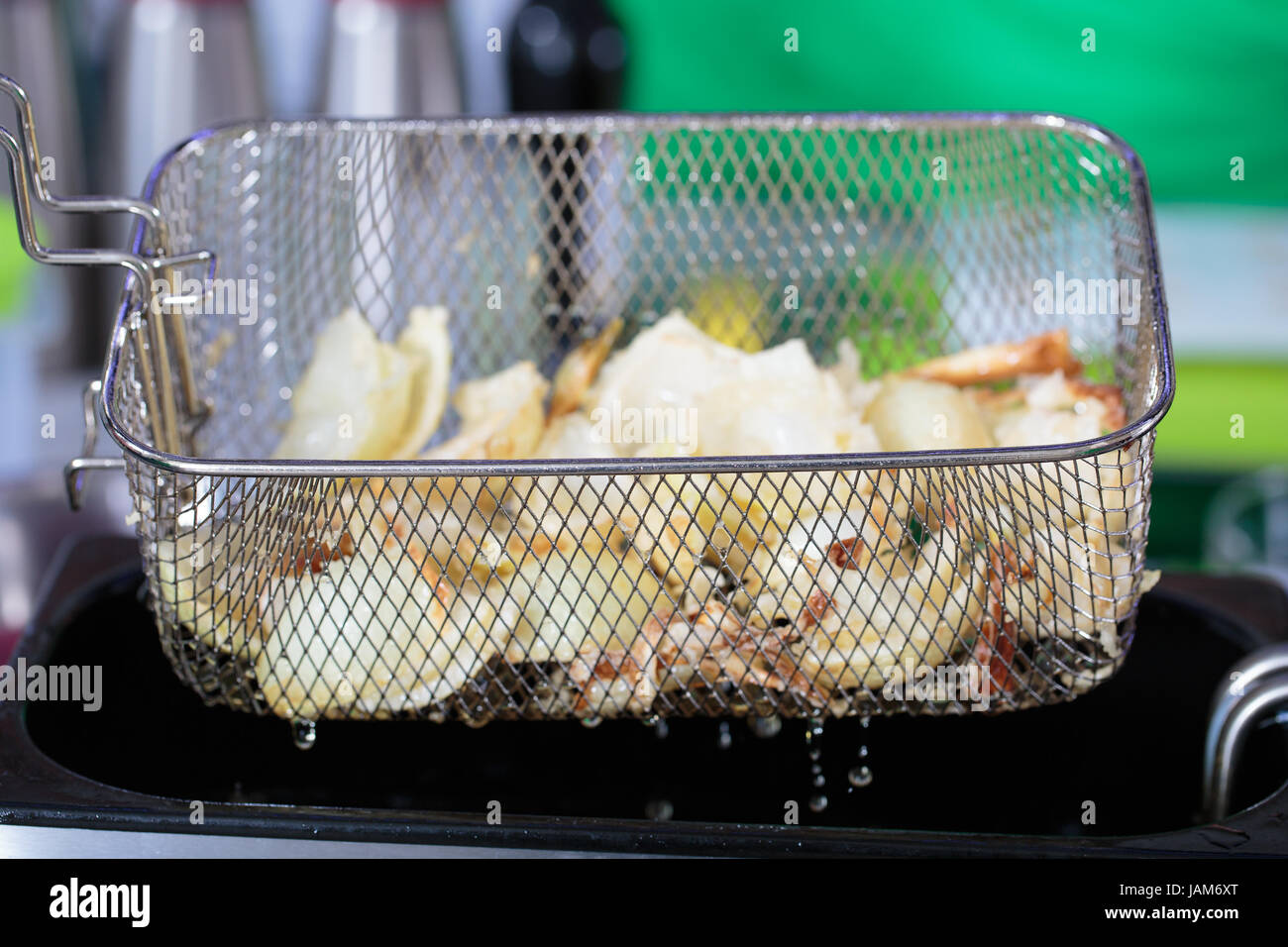 Deep fryer with food on restaurant kitchen Stock Photo - Alamy