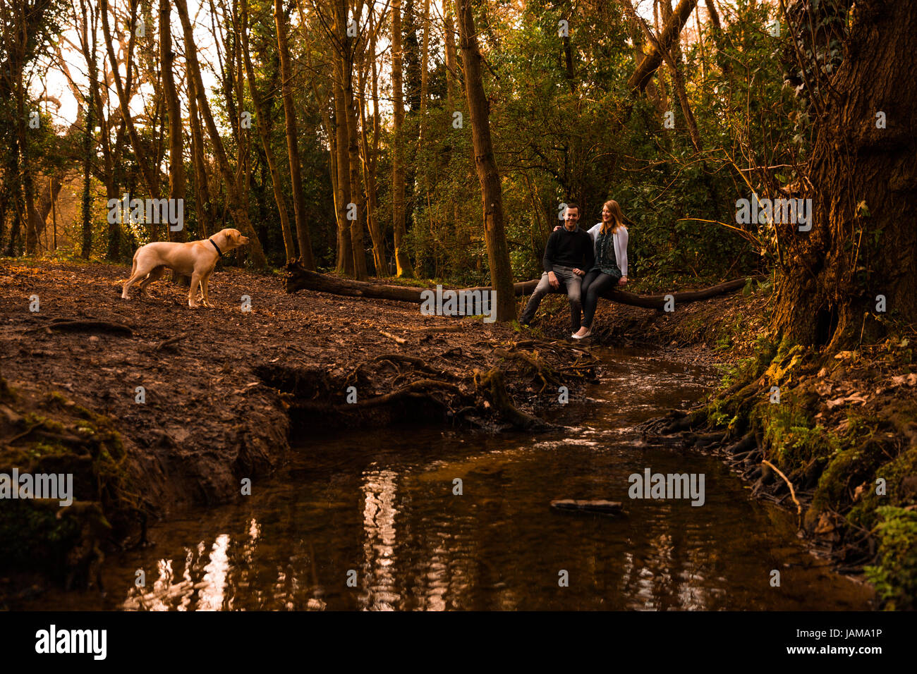 Couple by the stream Stock Photo - Alamy