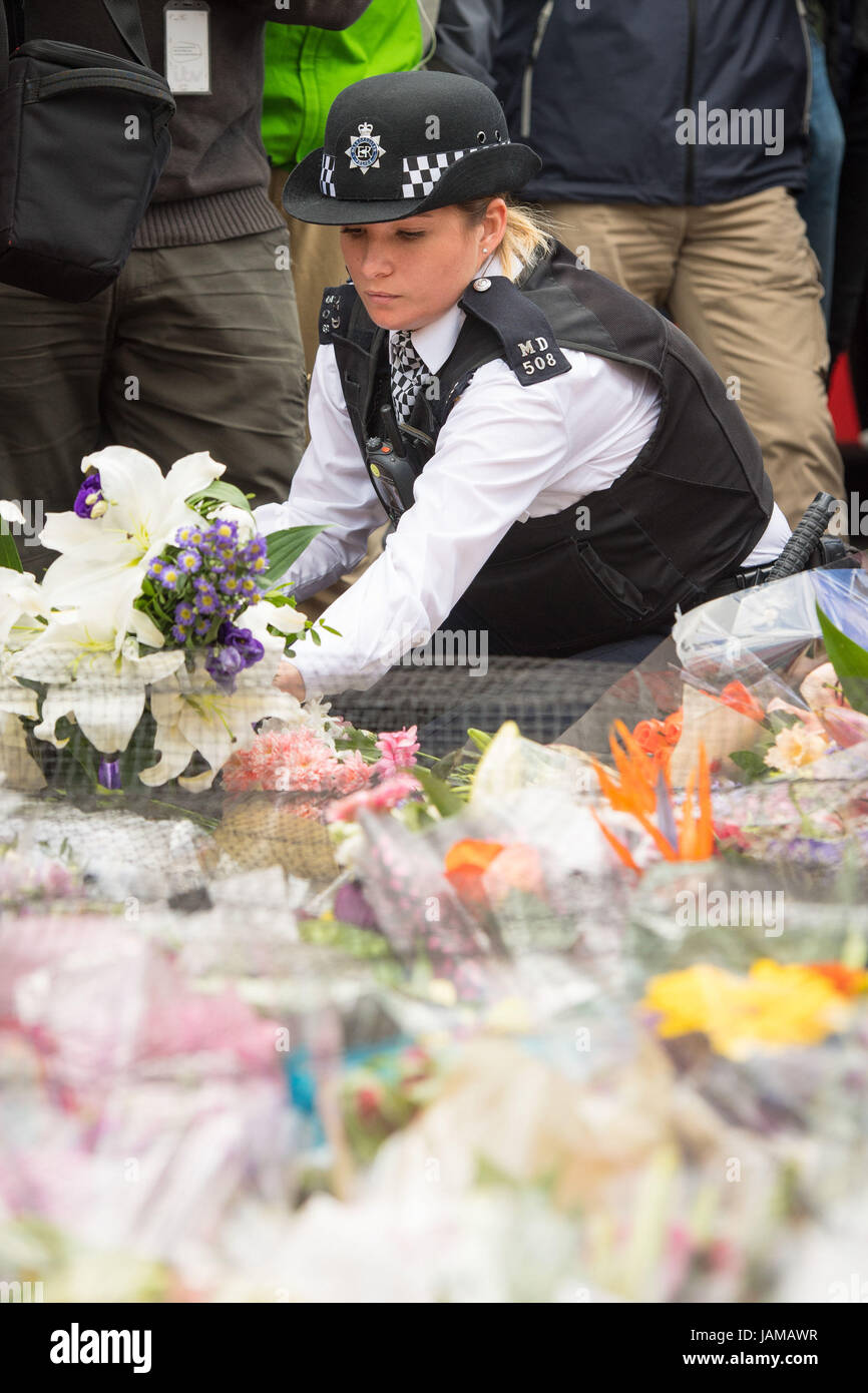 Police officer lays flowers hi-res stock photography and images - Alamy