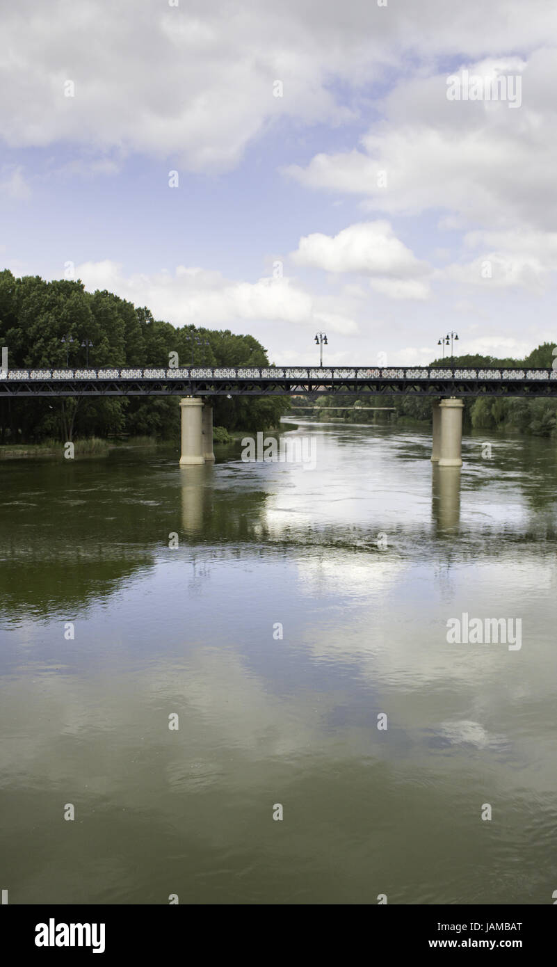 Bridge with river and nature with cloudy sky and reflection on water ...