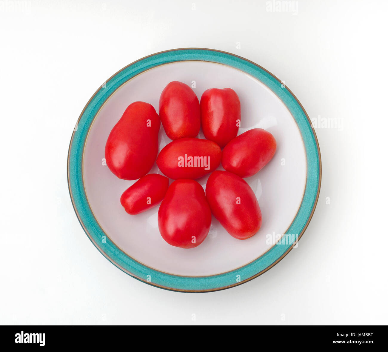 Still life arrangement of Italian Roma cooking tomatoes in round white ...