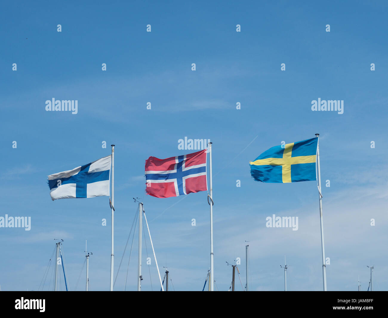 Three Scandinavian flags in a marina on a blue summer sky Stock Photo ...