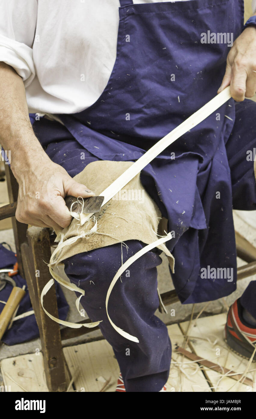 Worker cutting strips for wicker chairs, craftsman Stock Photo - Alamy