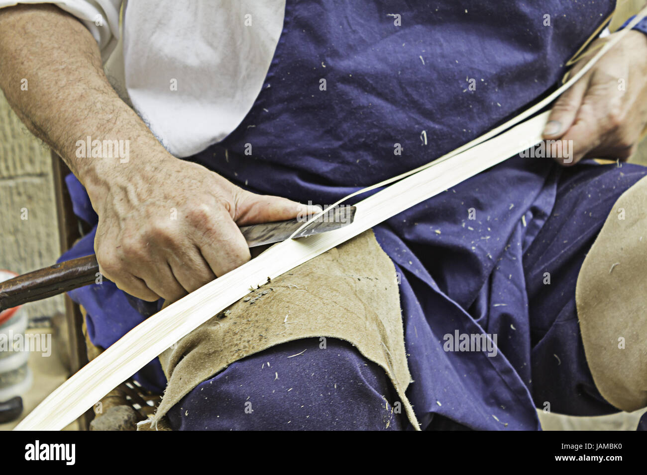 Worker cutting strips for wicker chairs, craftsman Stock Photo - Alamy