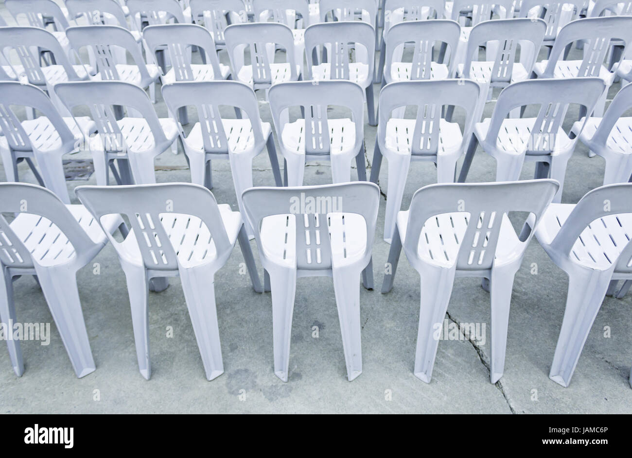 White plastic chairs in celebration and outdoor event Stock Photo - Alamy