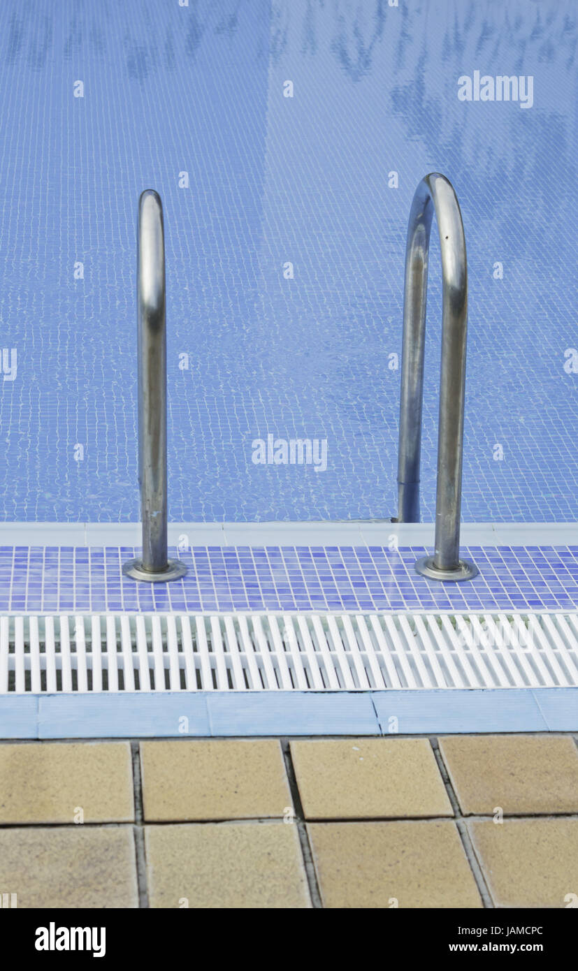 Turquoise blue water in pool with tiles and metal ladders, fun Stock ...