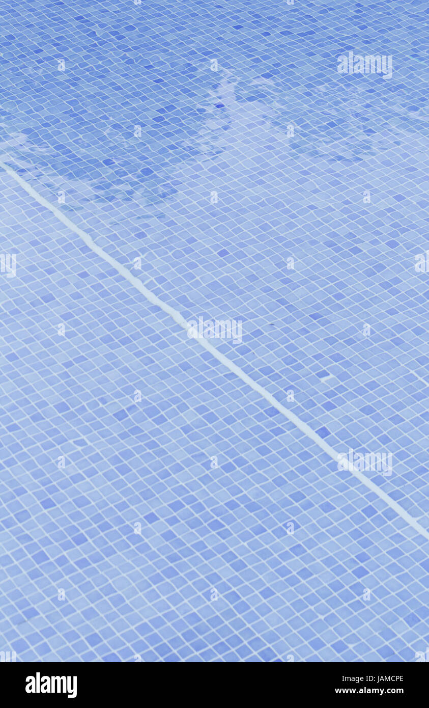 Swimming pool filled with moving water and blue tiles Stock Photo - Alamy