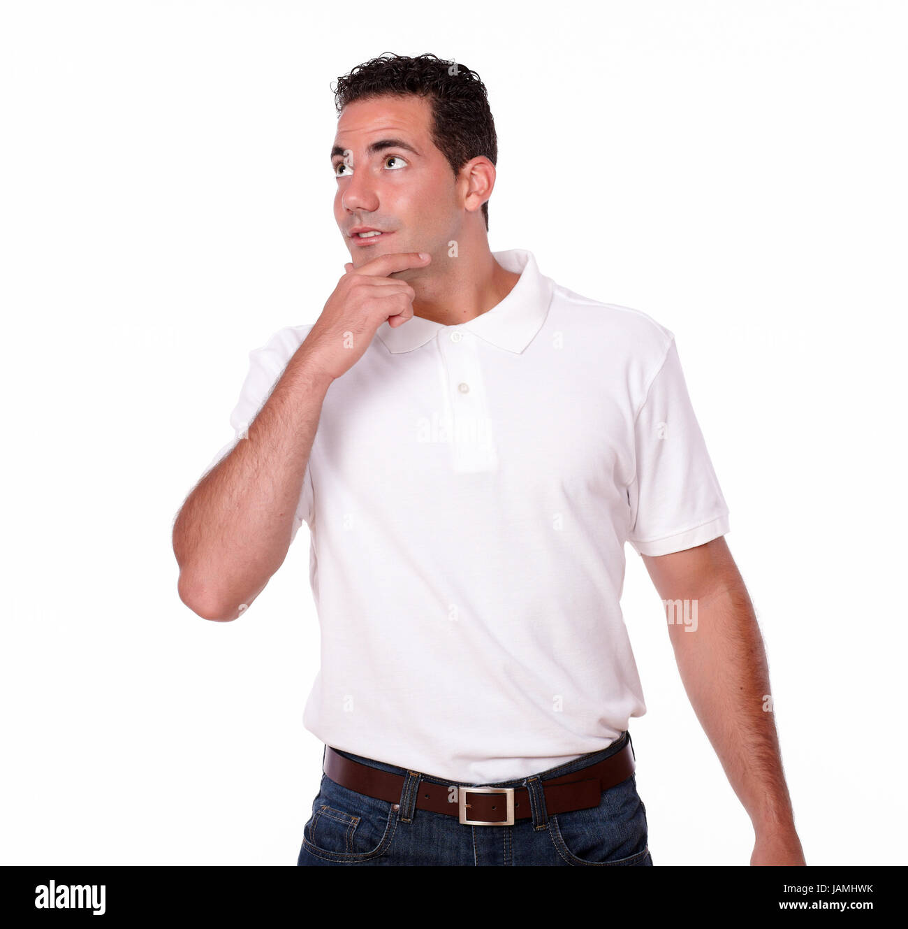 Portrait of a pensive gorgeous guy on white t-shirt looking at people ...