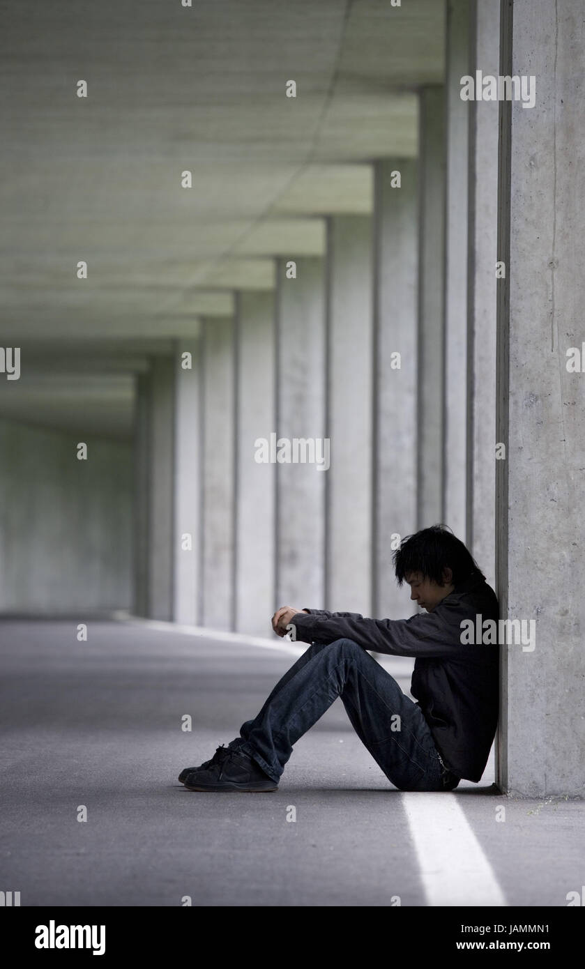 Young person,concrete column,sit,leant,sadly,depresses Stock Photo - Alamy