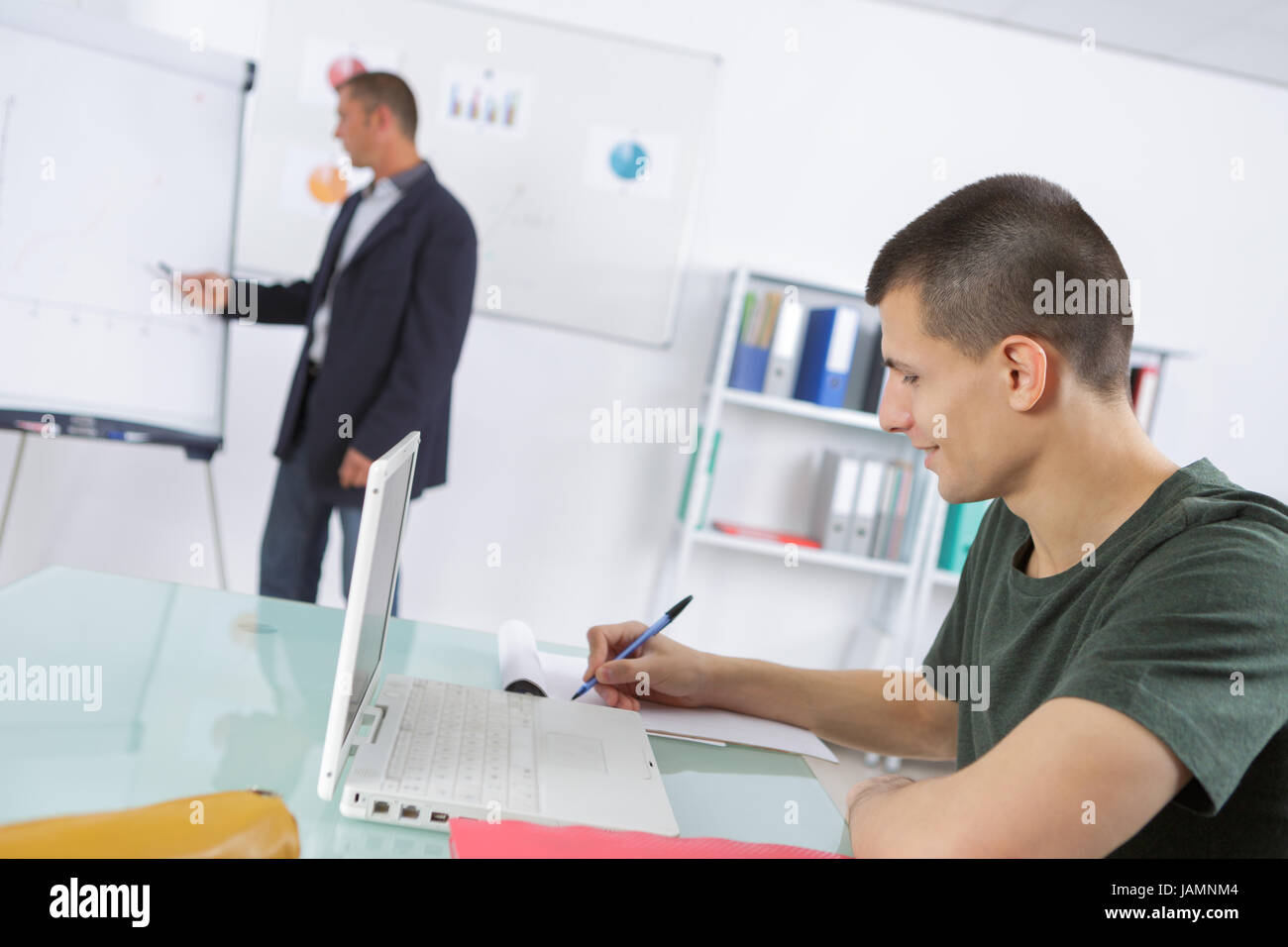 teacher with marker drawing scheme on white board in classroom Stock ...