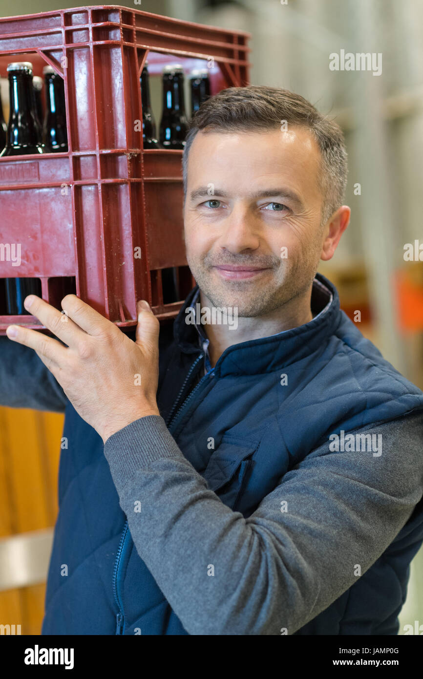 man carrying crate Stock Photo - Alamy