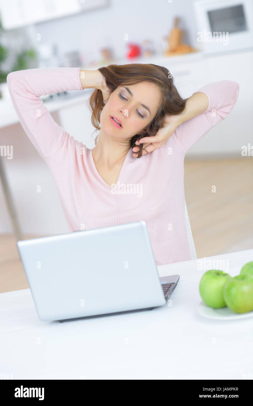 tired woman with laptop computer Stock Photo - Alamy
