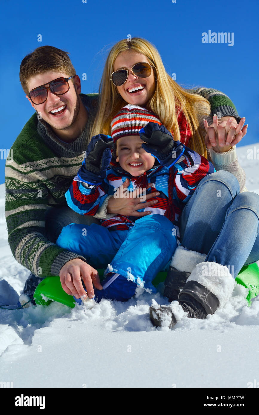 Winter season. Happy family having fun on fresh snow on vacation Stock ...
