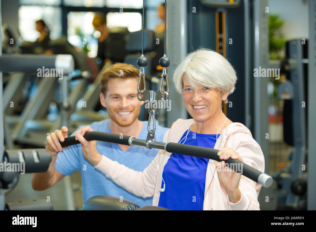sport coach training senior woman with stretching exercises Stock Photo ...
