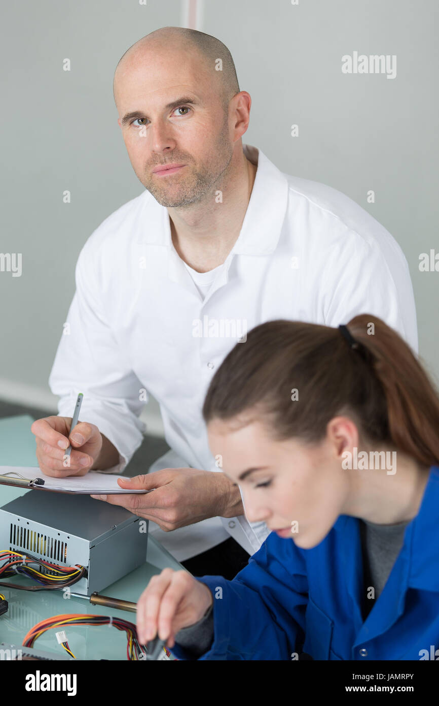 female pc technician soldering a chip from a desktop Stock Photo - Alamy