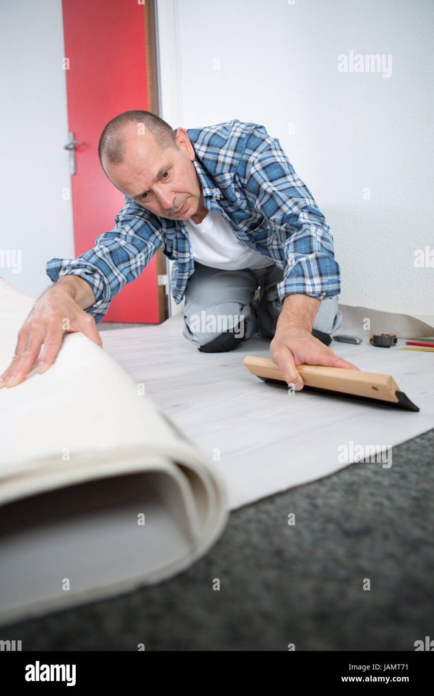 man laying carpet Stock Photo - Alamy