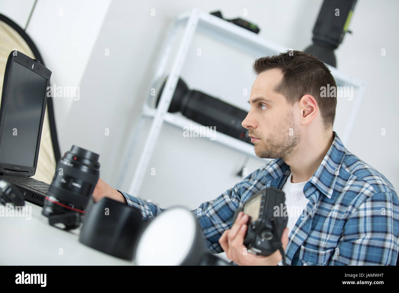 photographer working checking photos on laptop Stock Photo - Alamy