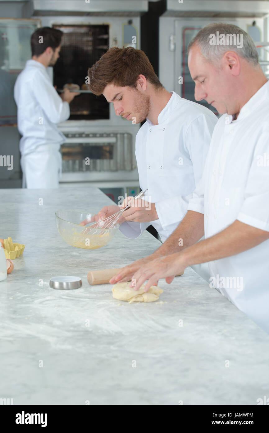 chef and apprentice preparing a cake together Stock Photo - Alamy