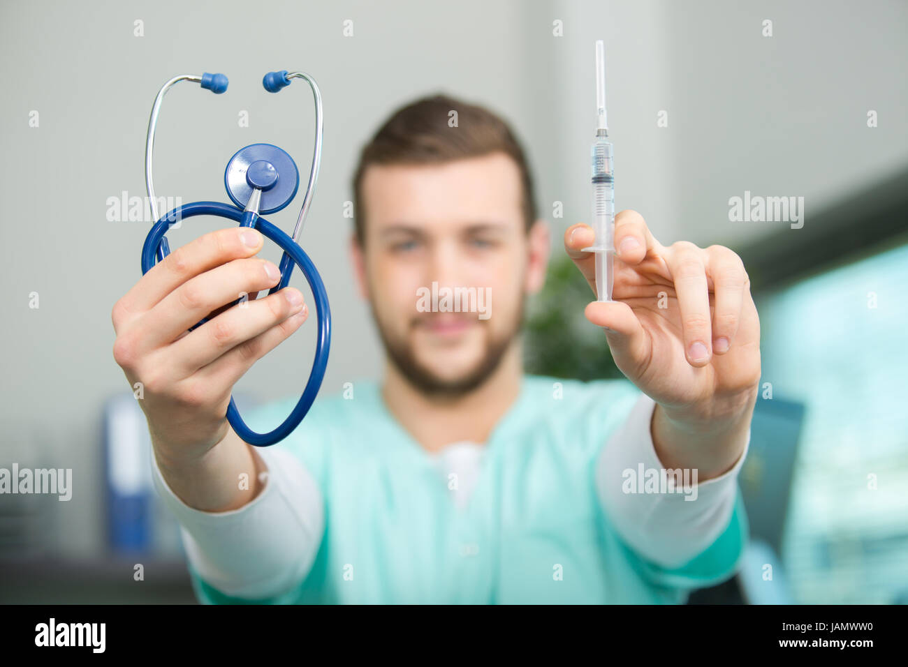 young man doctor with stethoscope preparing a injection Stock Photo - Alamy