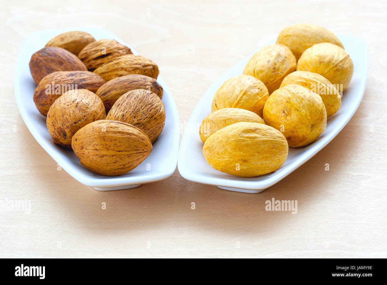 two plates with large nuts Stock Photo - Alamy