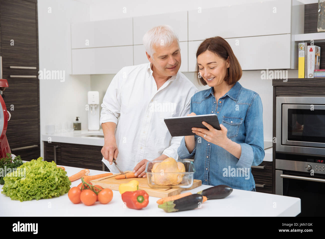Mature woman cooking kitchen hi-res stock photography and images - Alamy