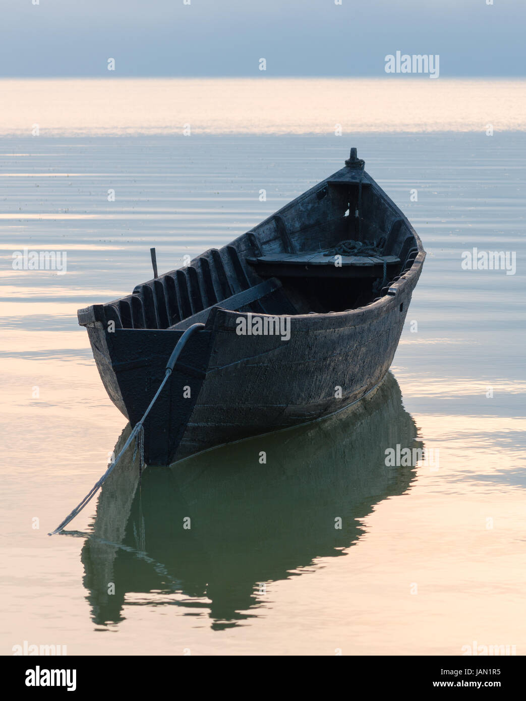 Old rowboat on the lake at sunset Stock Photo - Alamy