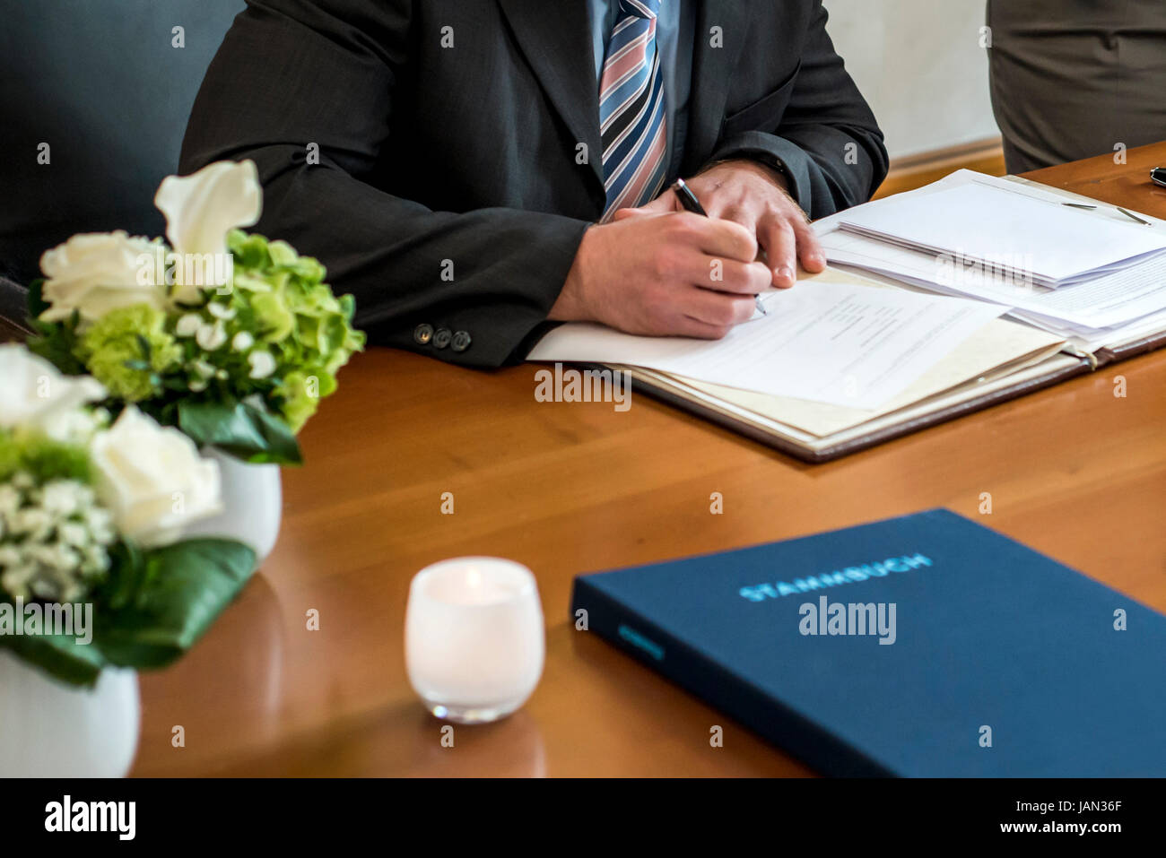 marriage elegant groom signing german wedding register, holding pen and ...