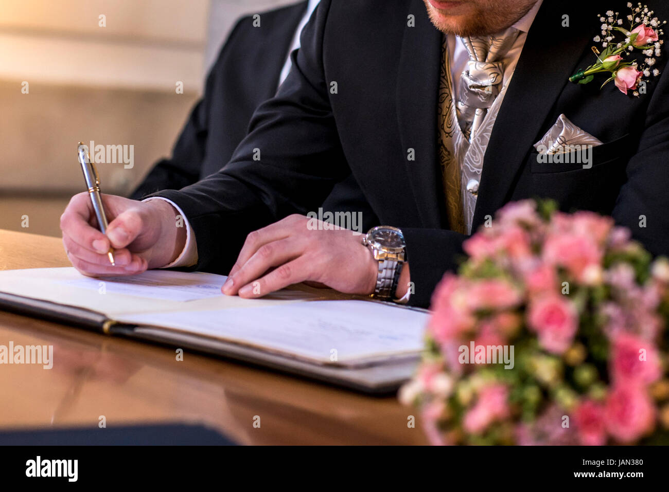 marriage elegant groom signing german wedding register, holding pen and ...