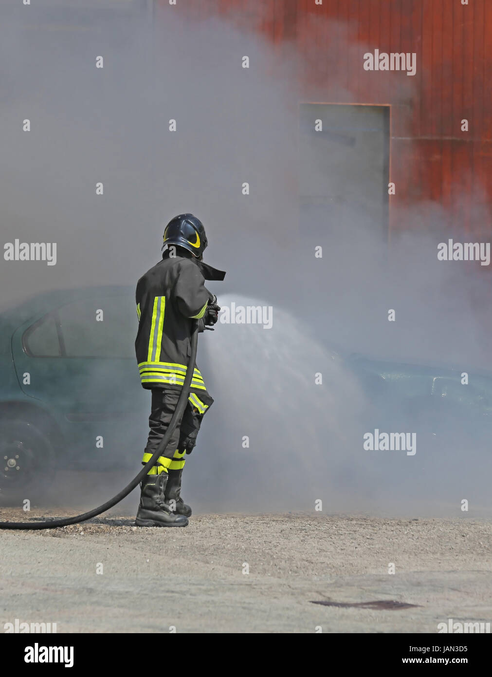 two firefighters with protective uniform and helmet off the fire Stock ...