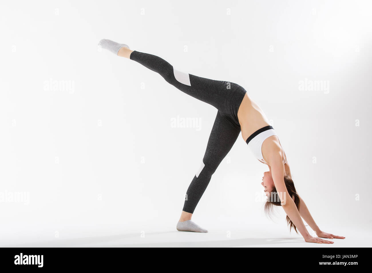 Young woman exercise yoga supported headstand Stock Photo - Alamy