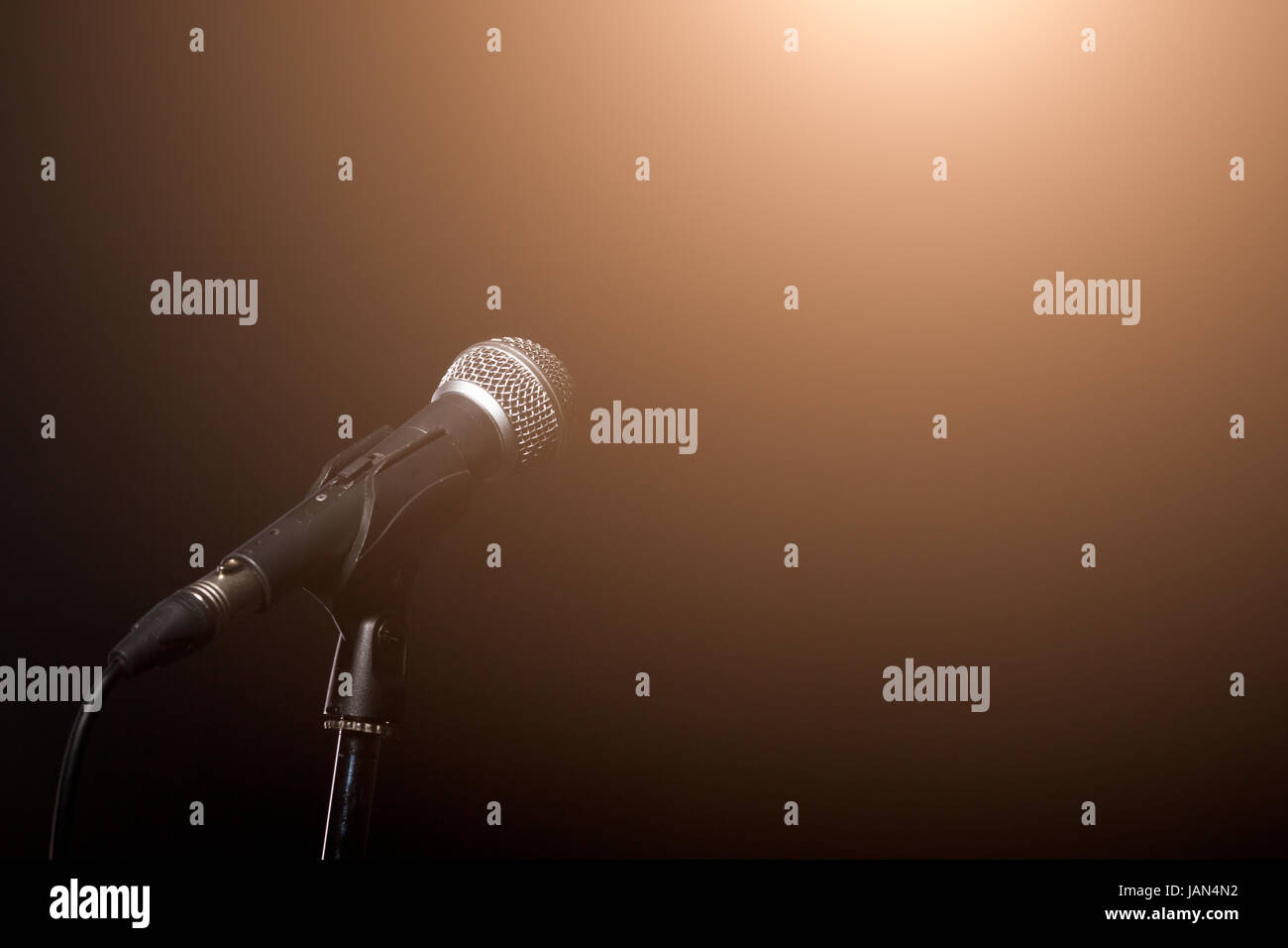 Microphone in light of spotlight Stock Photo - Alamy